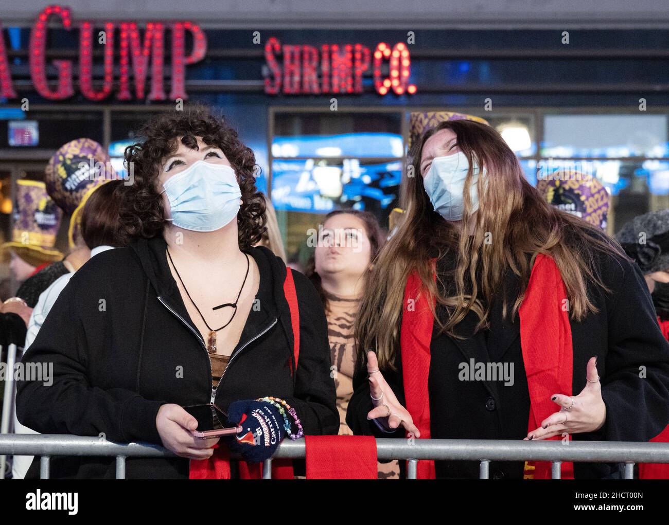 New York, USA. 31st Dec, 2021. People gather wearing face masks to ...