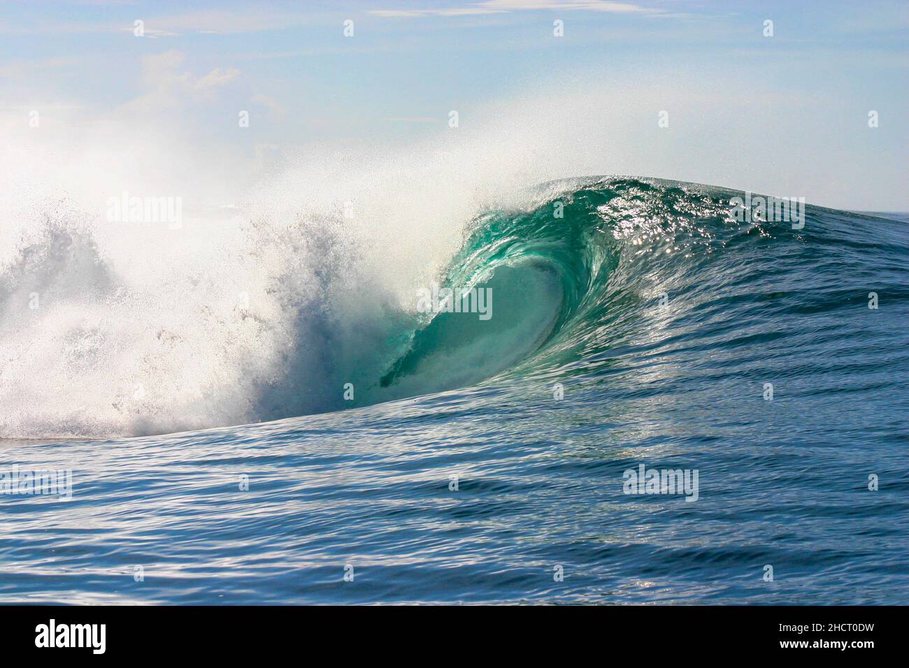 A wave breaks on shallow coral reef in Samoa in the South Pacific Stock ...
