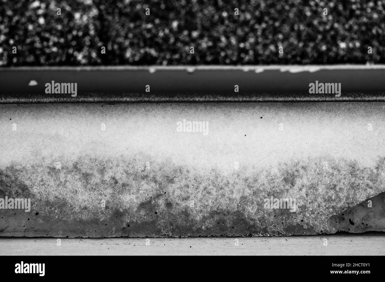 Ice and snow building up inside a rooftop gutter system on a ...