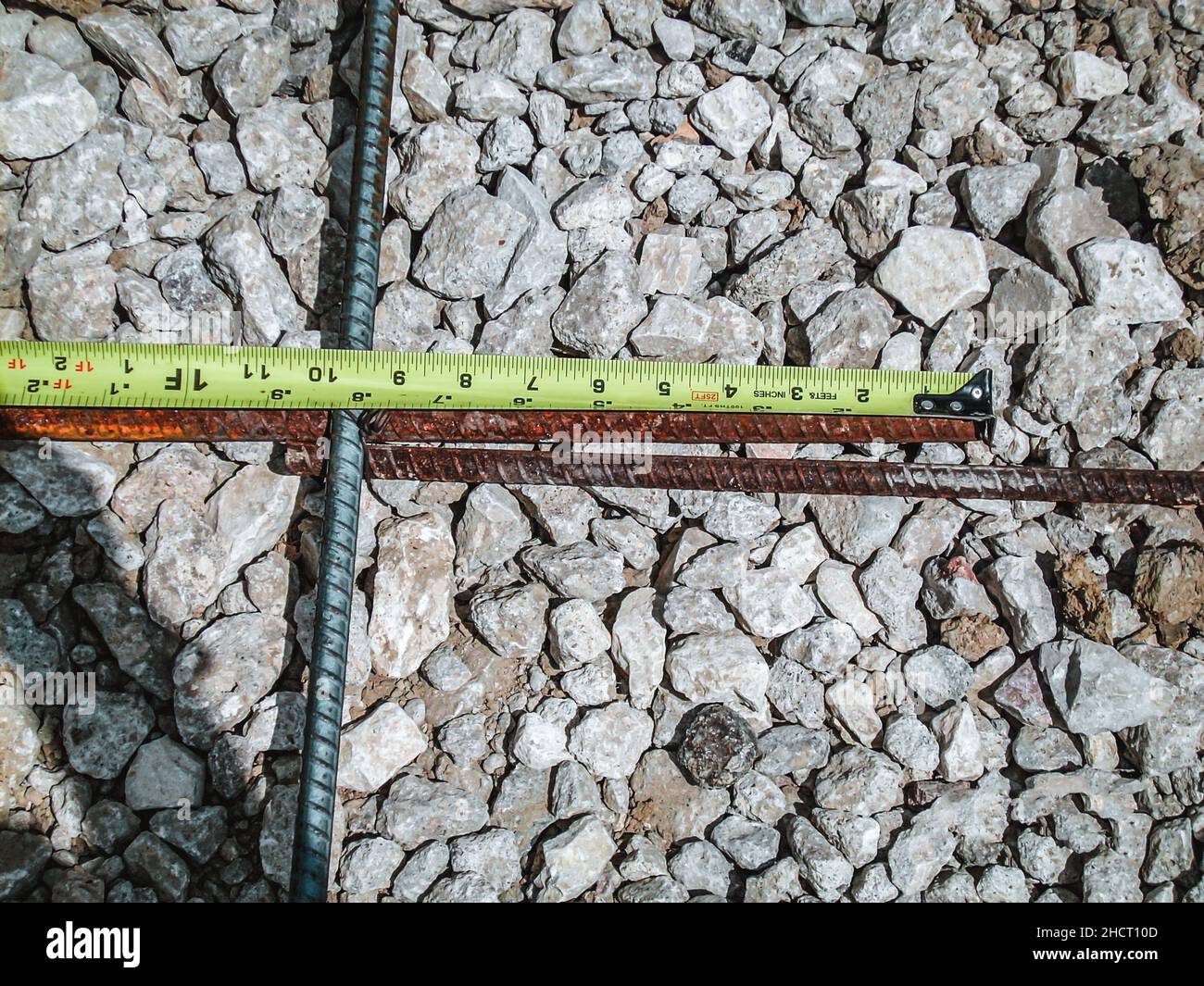 Inspecting and documenting the rebar overlap with a measuring tape at a ...