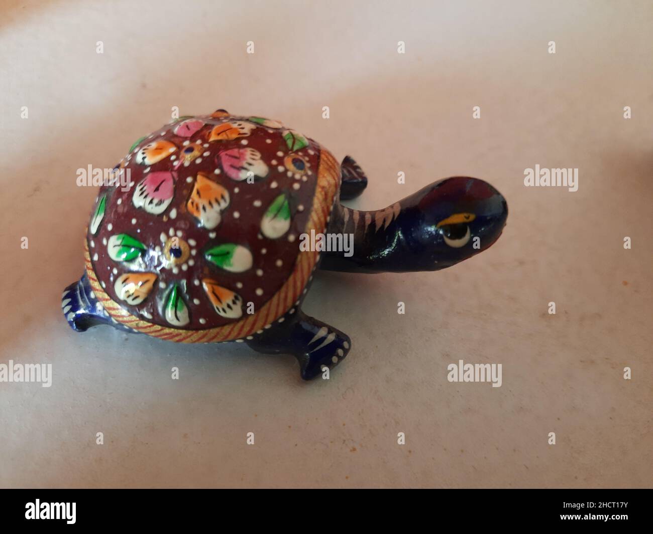 Colored Tortoise carved in wood as a show peace Stock Photo - Alamy