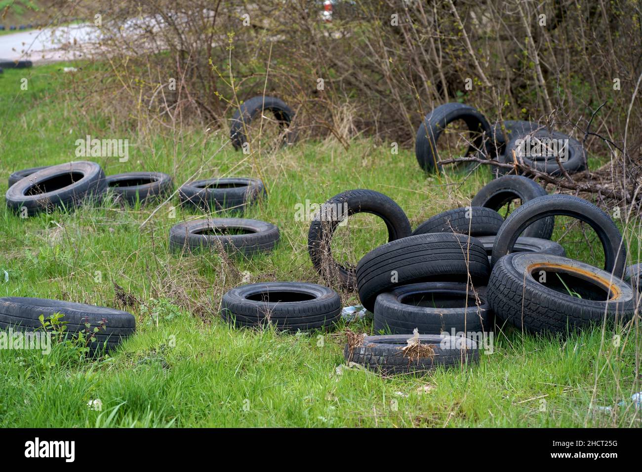 tires from car wheels are scattered on the grass Stock Photo - Alamy