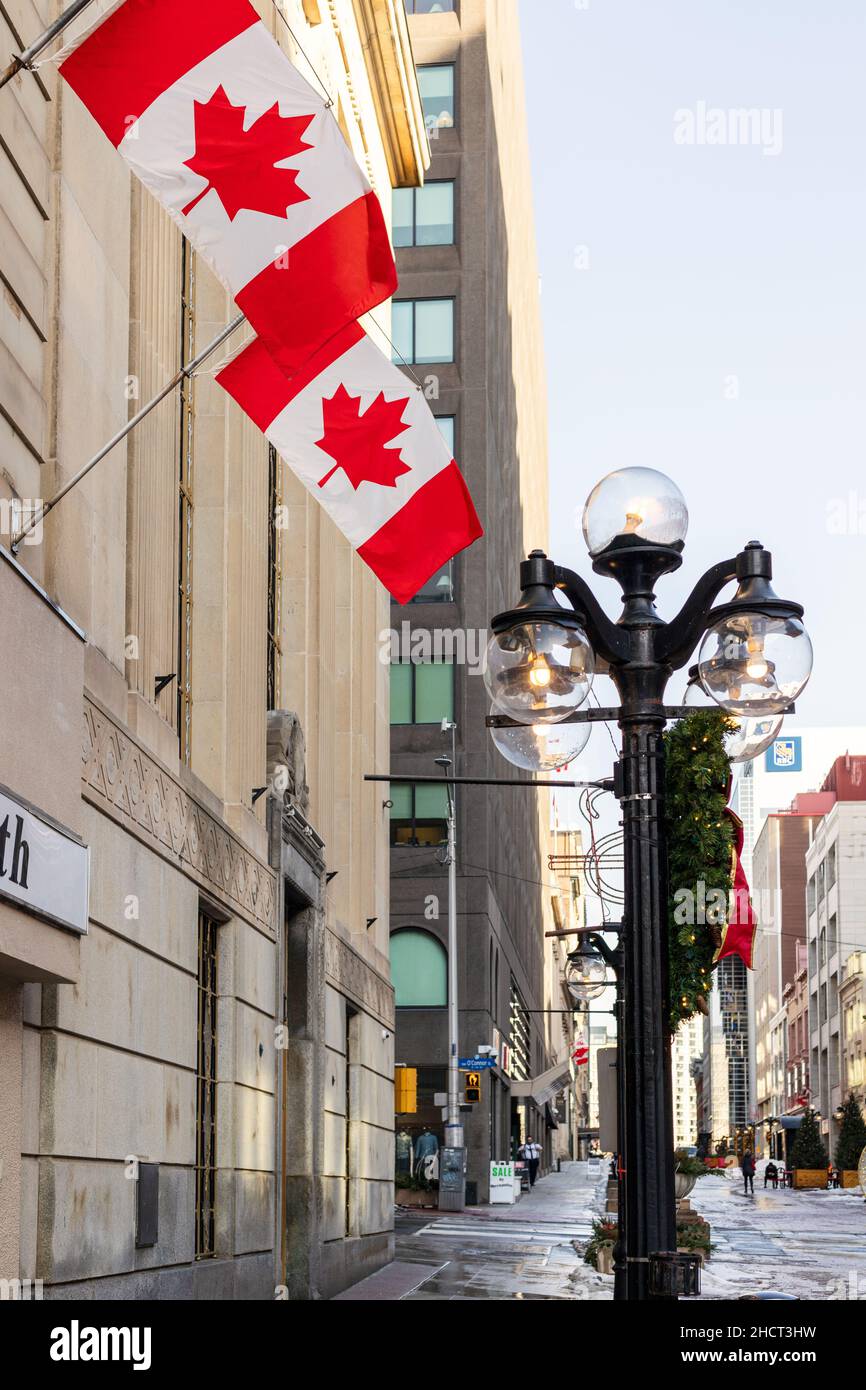 Ottawa, Canada - December 16, 2021: Cityscape street view with canadian flags on buildings in ...