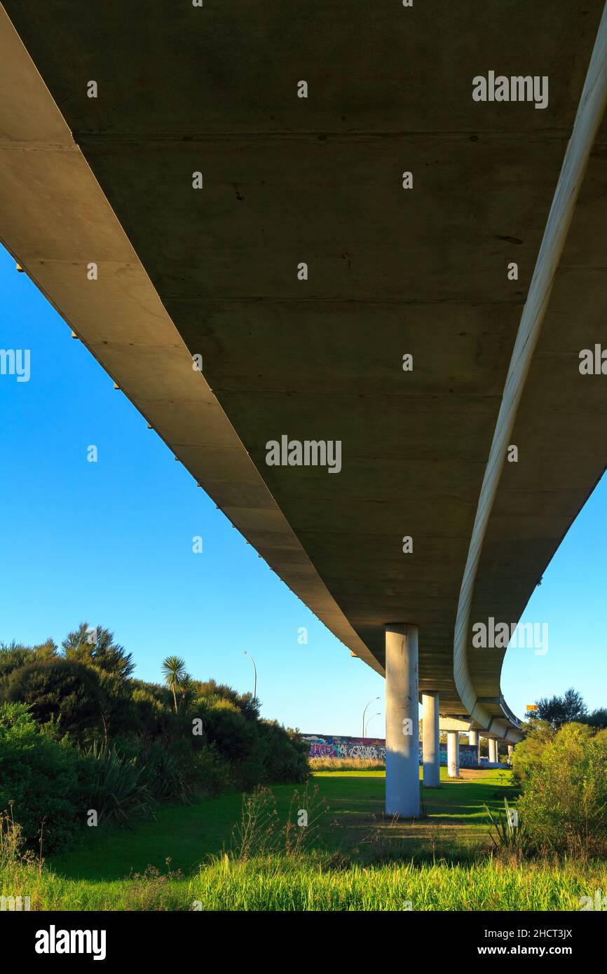 A long, curving highway underpass, seen from underneath Stock Photo - Alamy