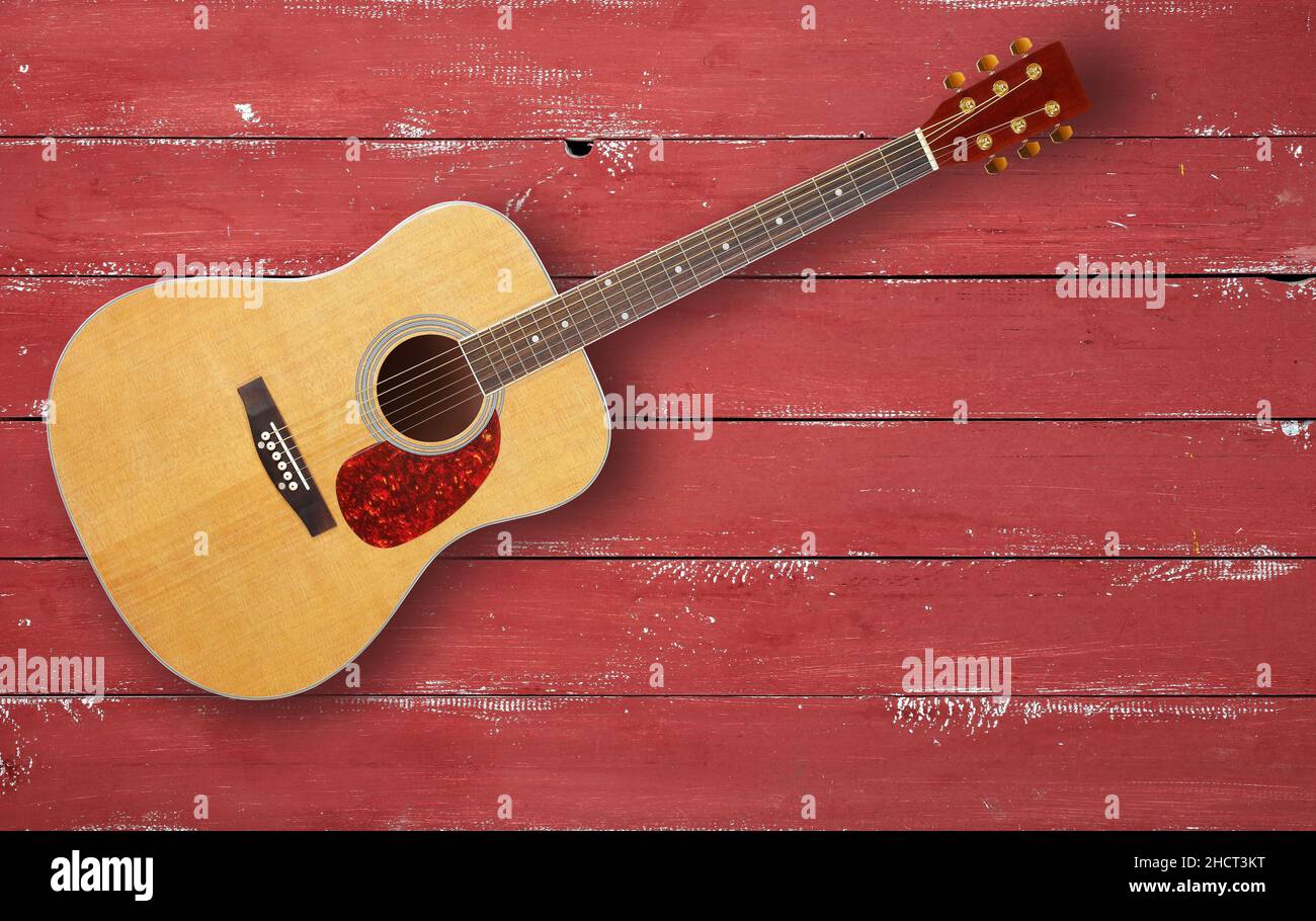 Musical instrument - Top view acoustic guitar on a red wood background ...