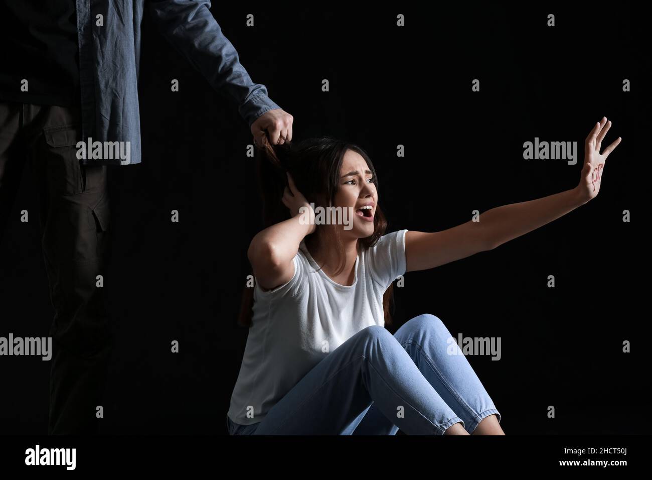 Man and his victim on dark background. Violence concept Stock Photo - Alamy