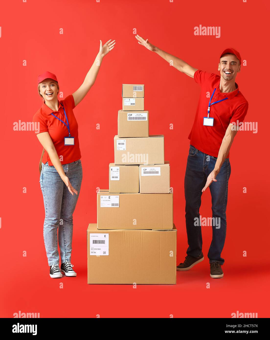 Couriers with many parcels on color background Stock Photo - Alamy