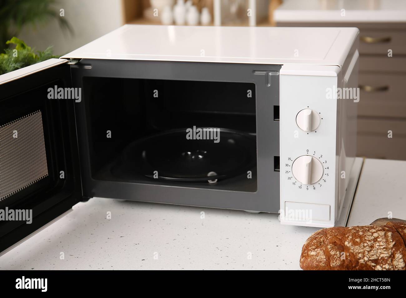 Open microwave oven on counter in kitchen, closeup Stock Photo - Alamy