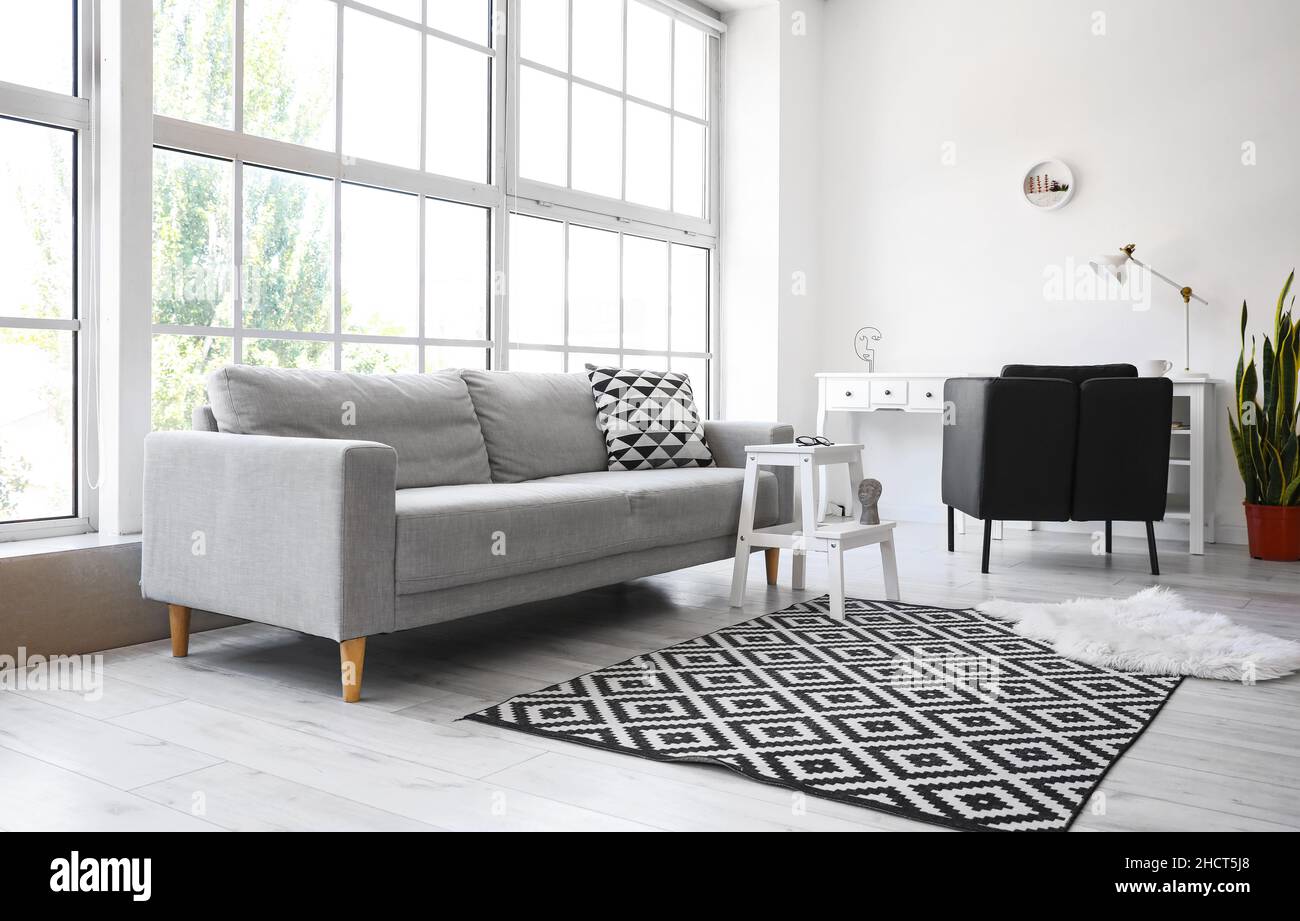 Interior of light living room with white step stool and sofa Stock ...