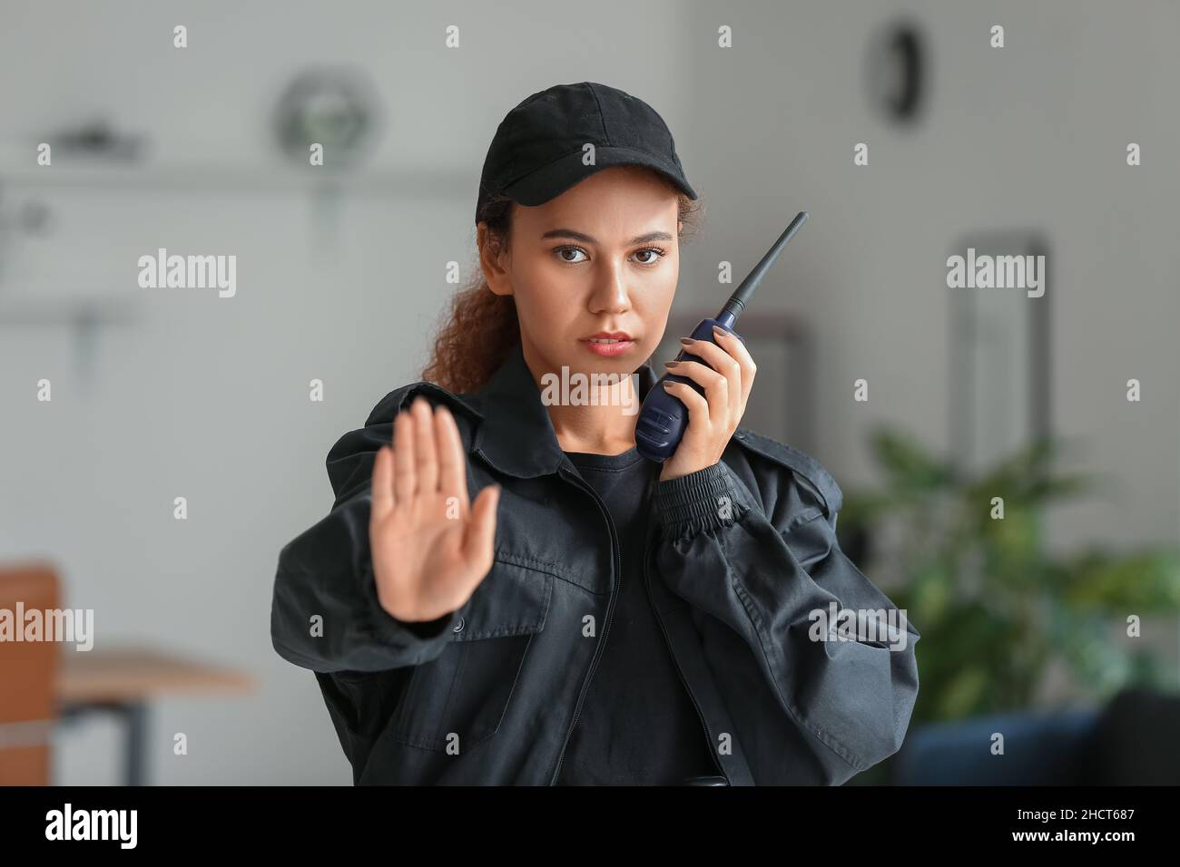 African-American female security guard with radio transmitter showing ...
