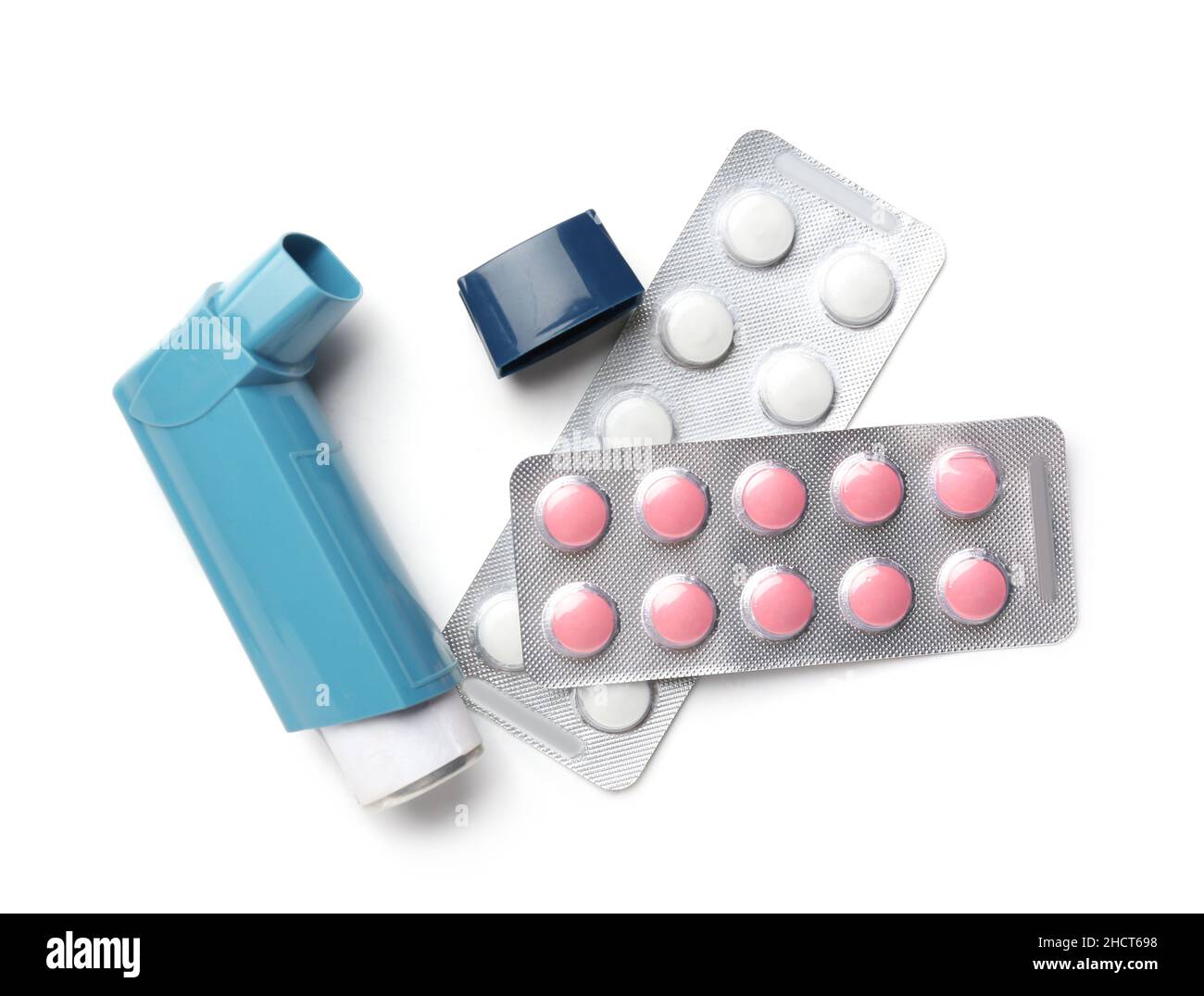 Modern asthma inhaler and blister packs of pills on white background ...
