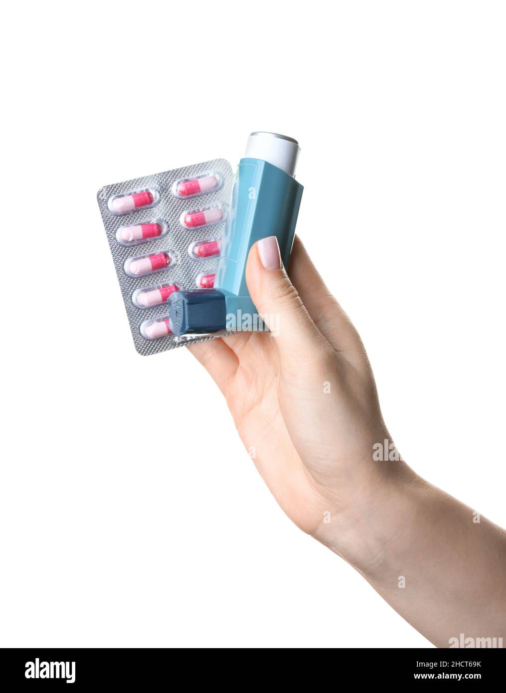 Female hand with modern asthma inhaler and blister pack of pills on ...
