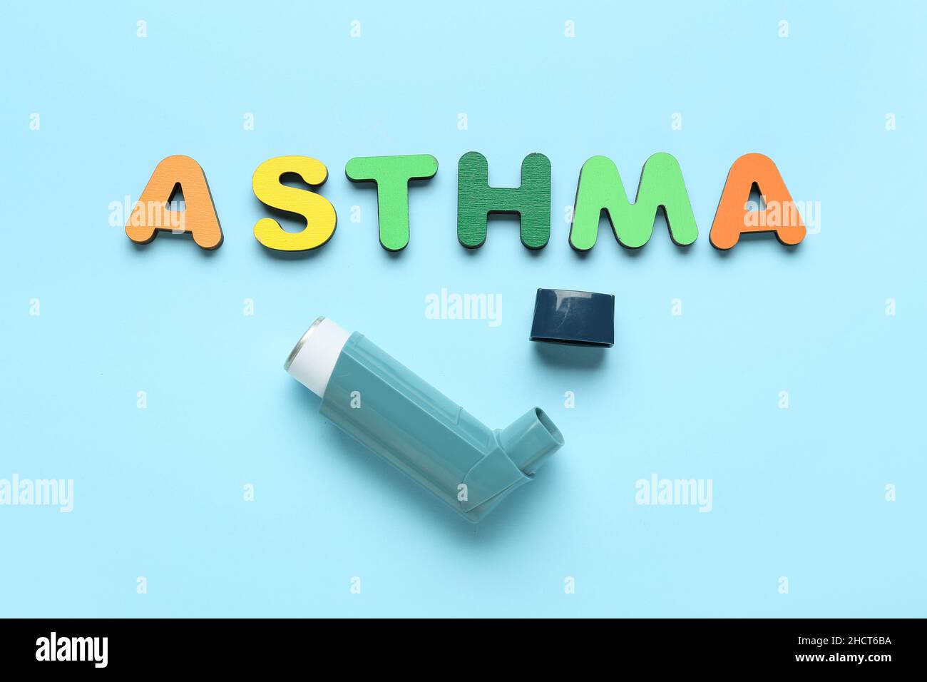 Word ASTHMA and modern inhaler on blue background Stock Photo - Alamy