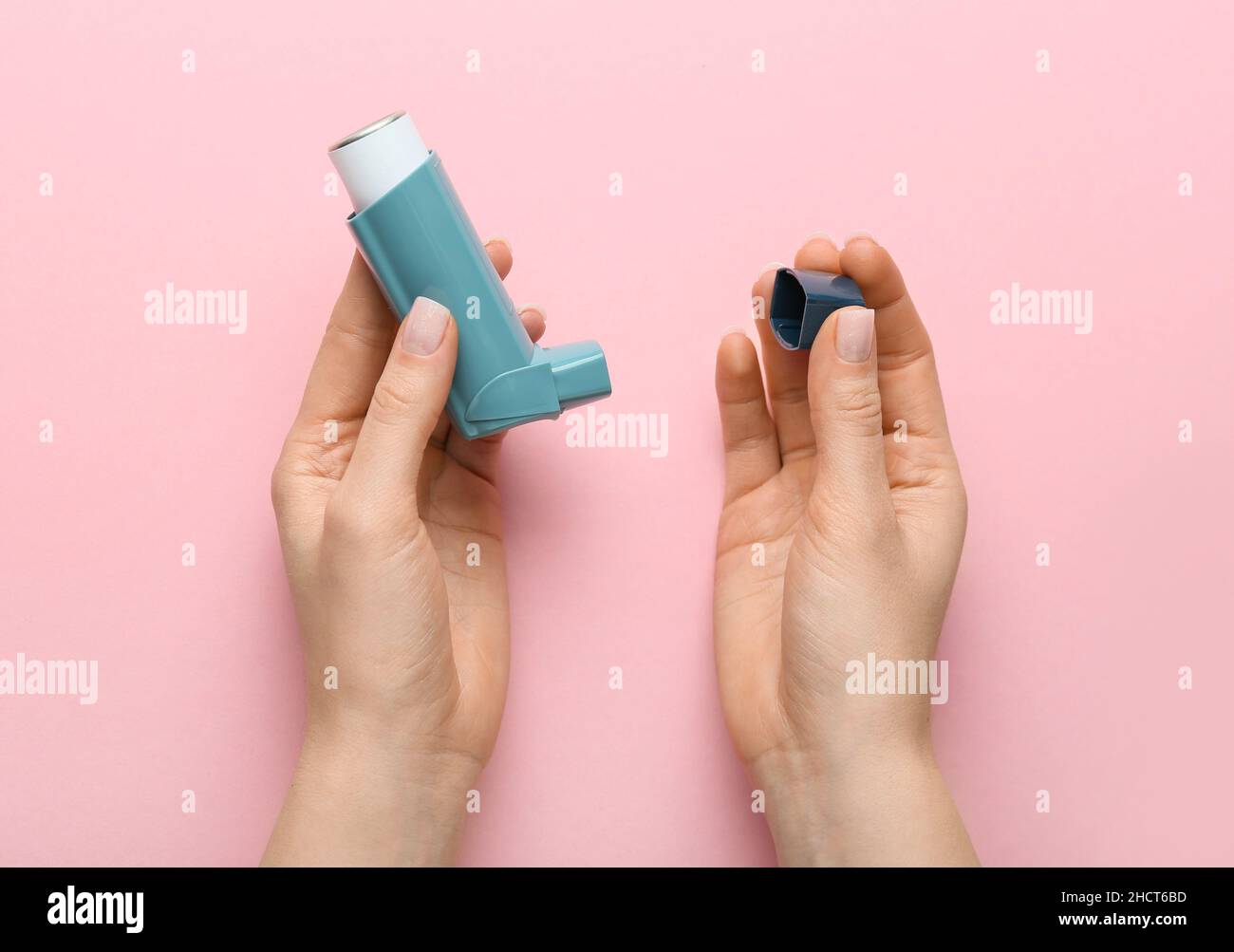 Female hands with modern asthma inhaler on color background Stock Photo ...