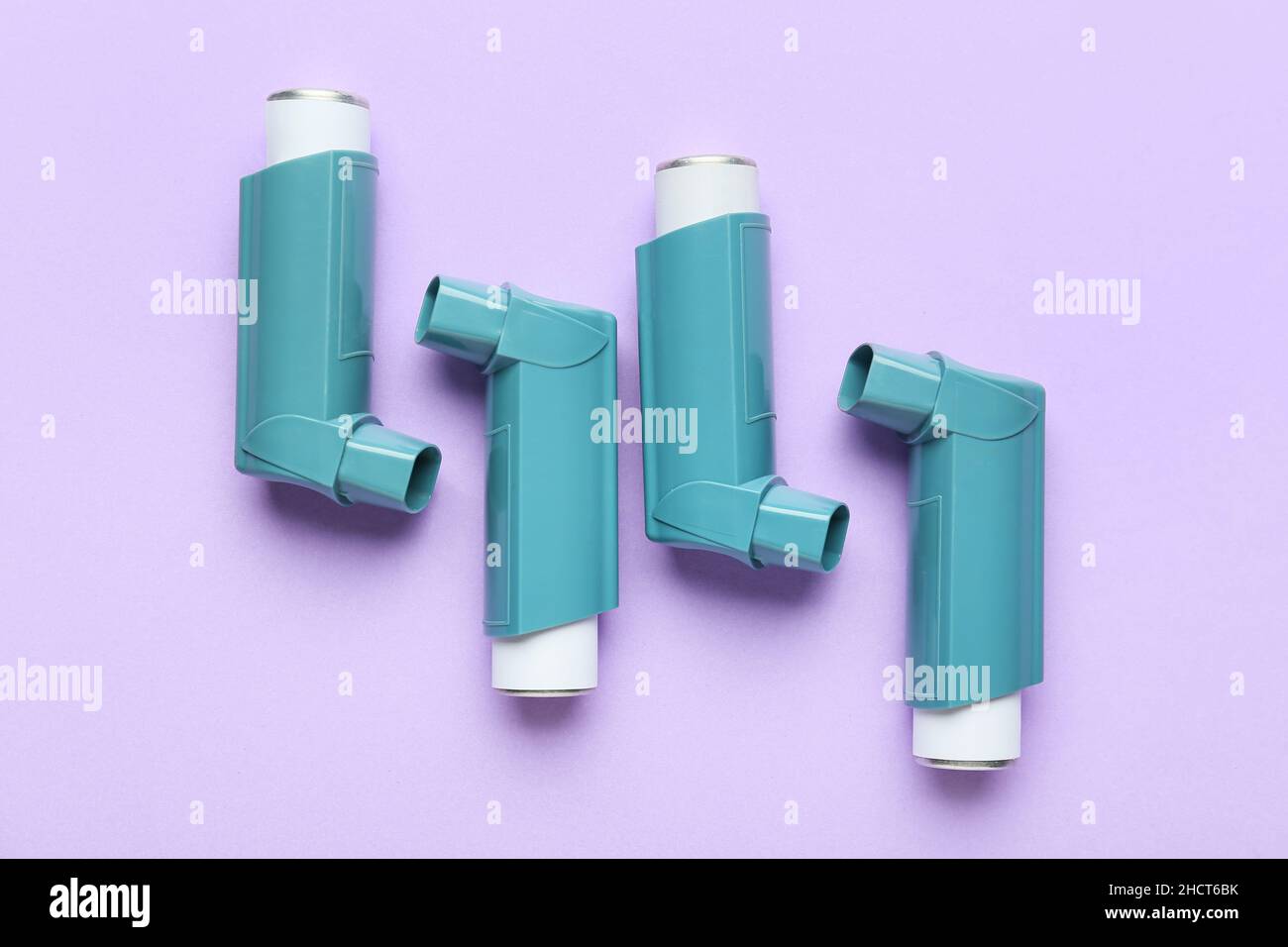 Modern asthma inhalers on color background Stock Photo - Alamy