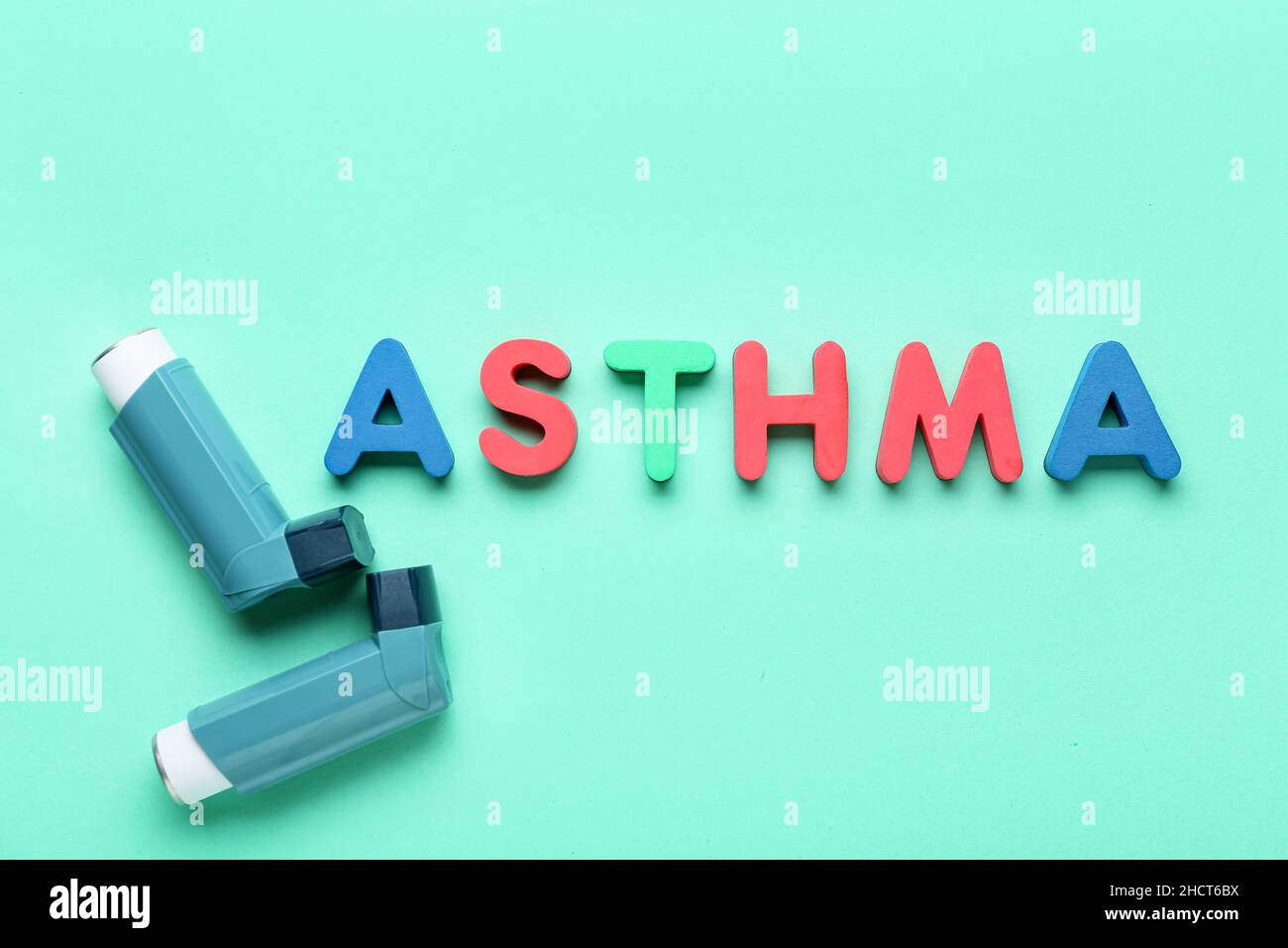 Inhalers and word ASTHMA on color background Stock Photo - Alamy