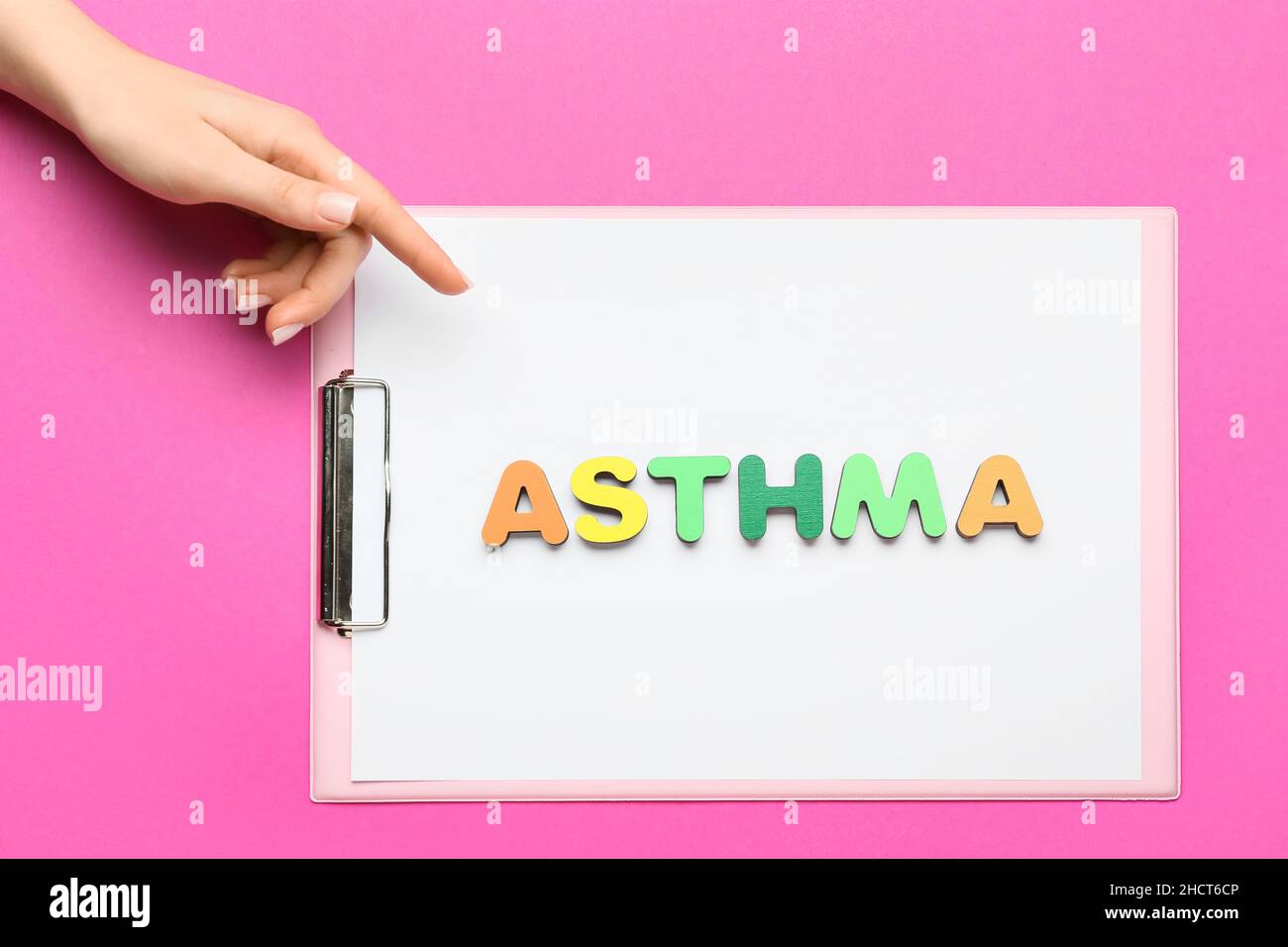 Female hand pointing at word ASTHMA on color background Stock Photo - Alamy