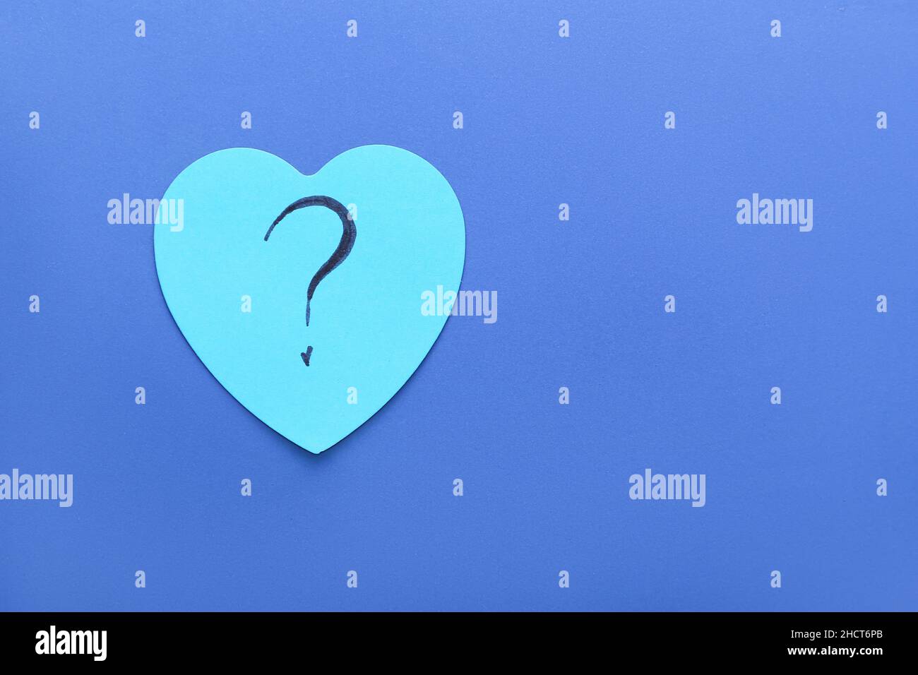 Heart shaped sticky note with question mark on blue background Stock ...