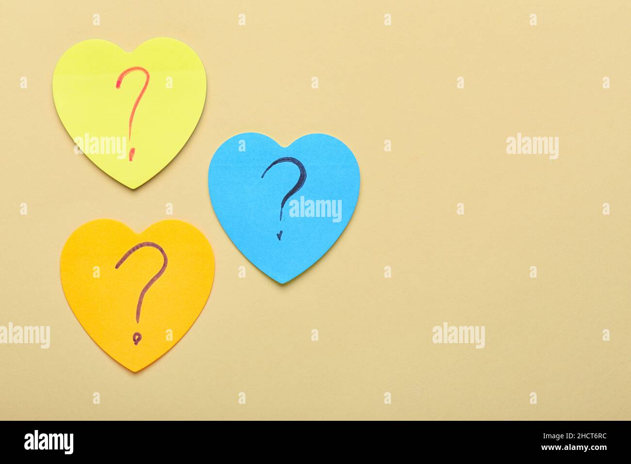 Heart shaped sticky notes with question marks on beige background Stock ...