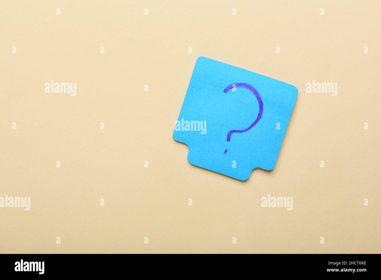Blue sticky note with question mark on beige background Stock Photo - Alamy
