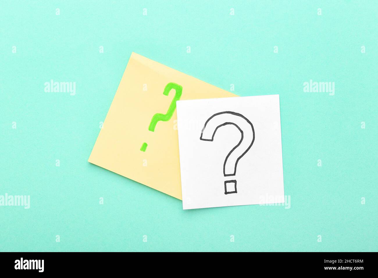 Sticky notes with question marks on blue background Stock Photo - Alamy