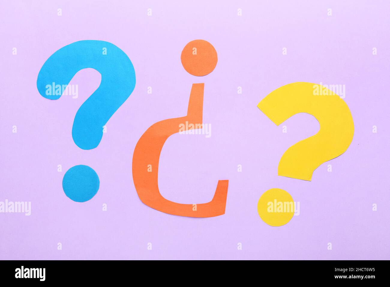 Question marks made of paper on lilac background Stock Photo - Alamy