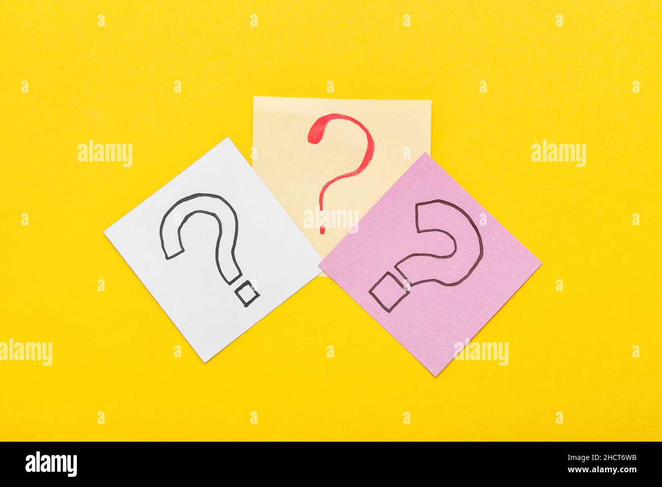 Sticky notes with question marks on yellow background Stock Photo - Alamy