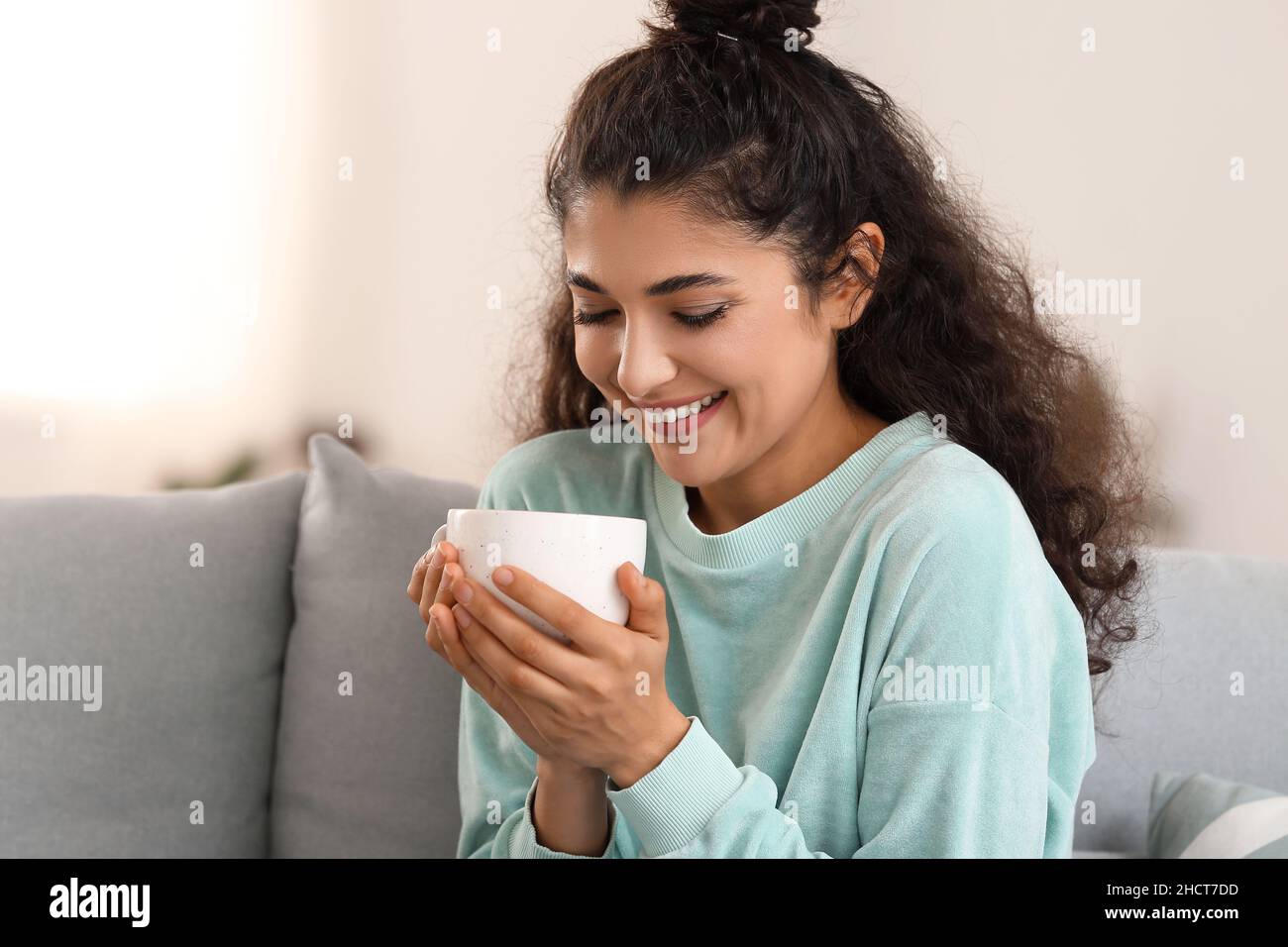Beautiful woman drinking tea at home Stock Photo - Alamy