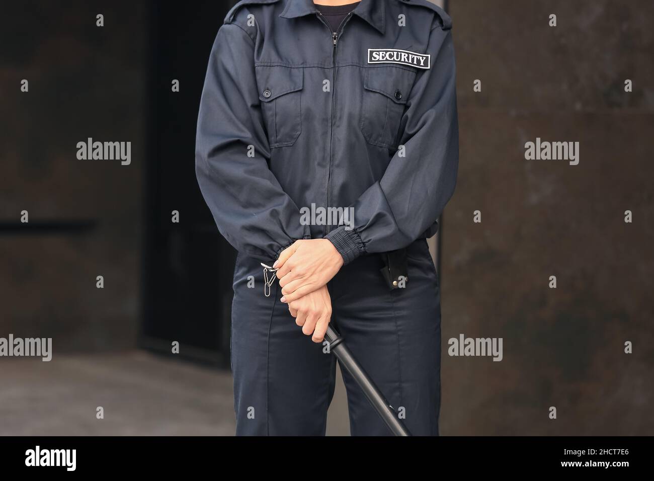 Female security guard with baton outdoors Stock Photo - Alamy