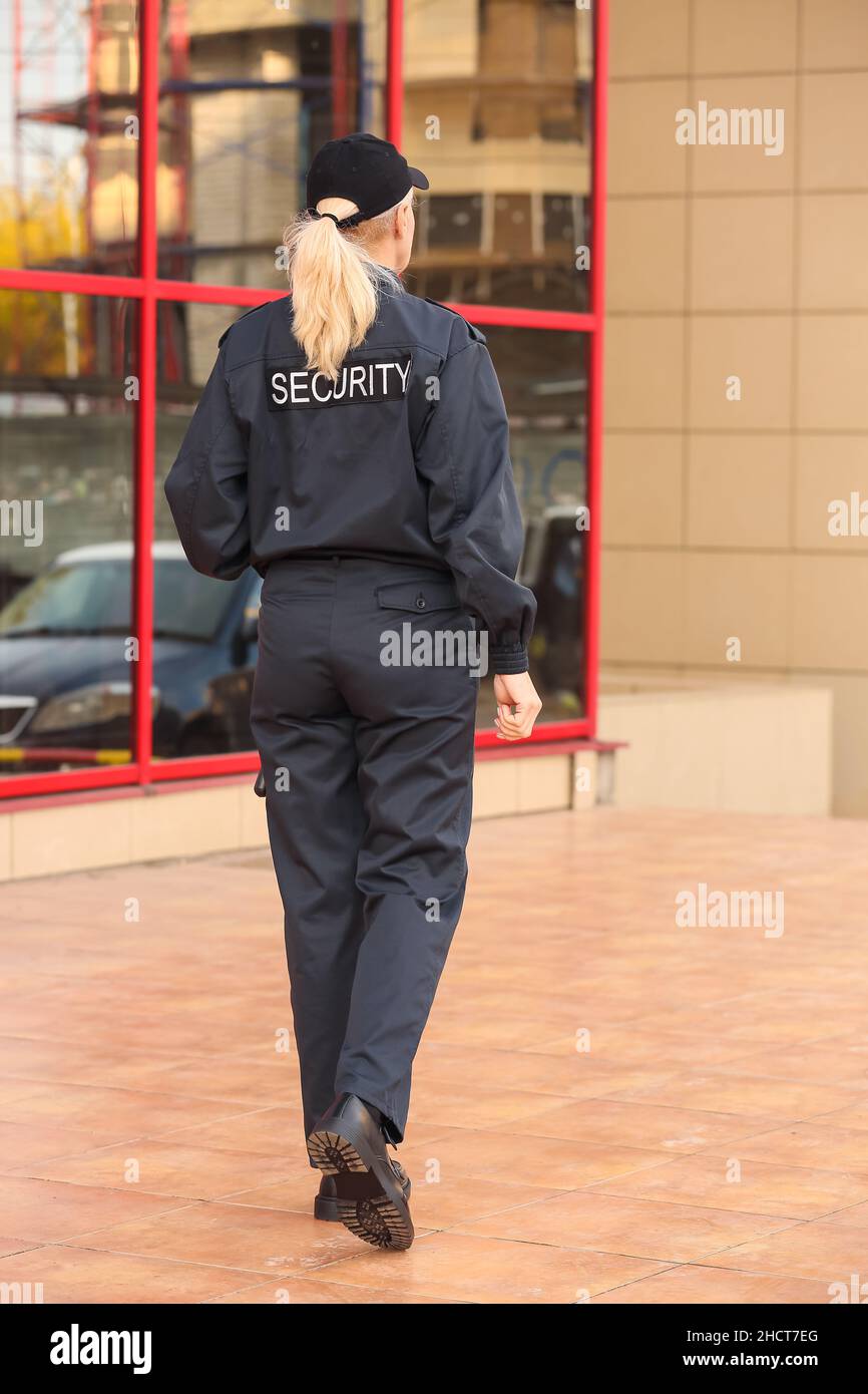 Female security guard outdoors, back view Stock Photo - Alamy