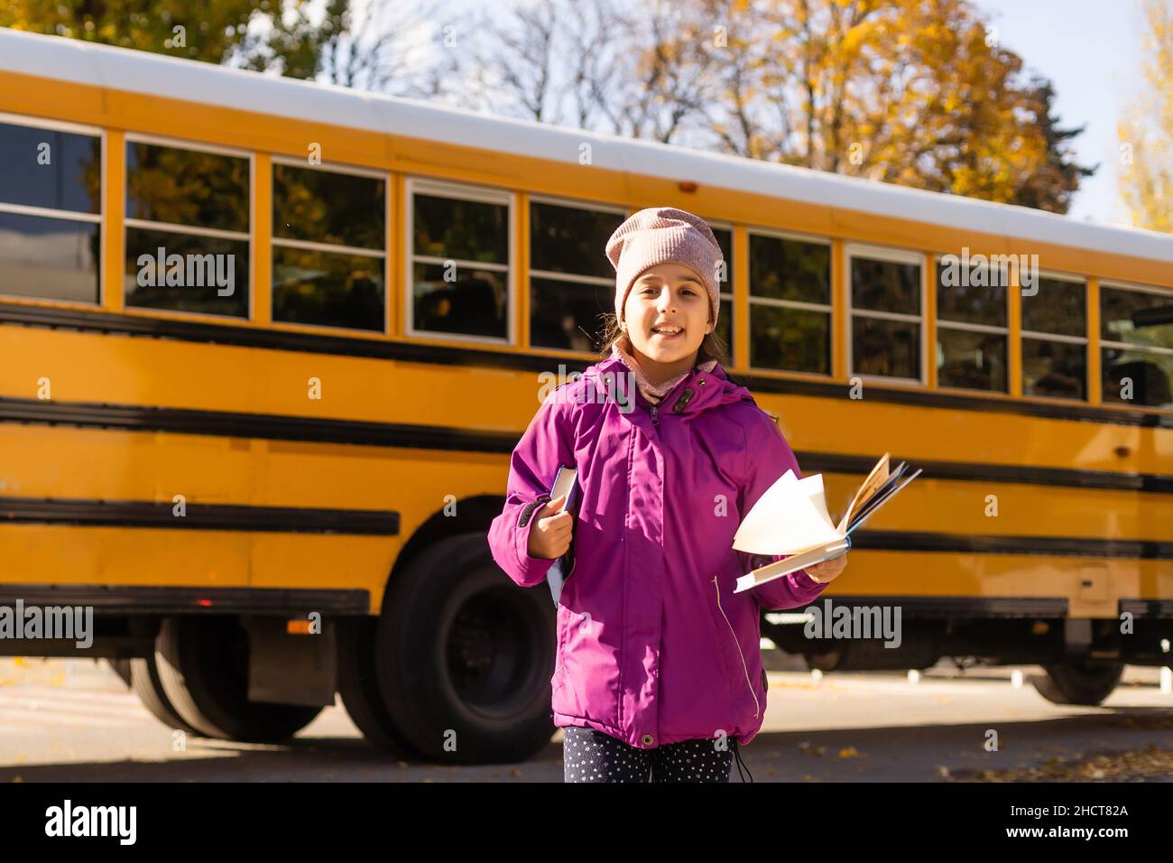 Pre teen girl getting on school bus Stock Photo - Alamy
