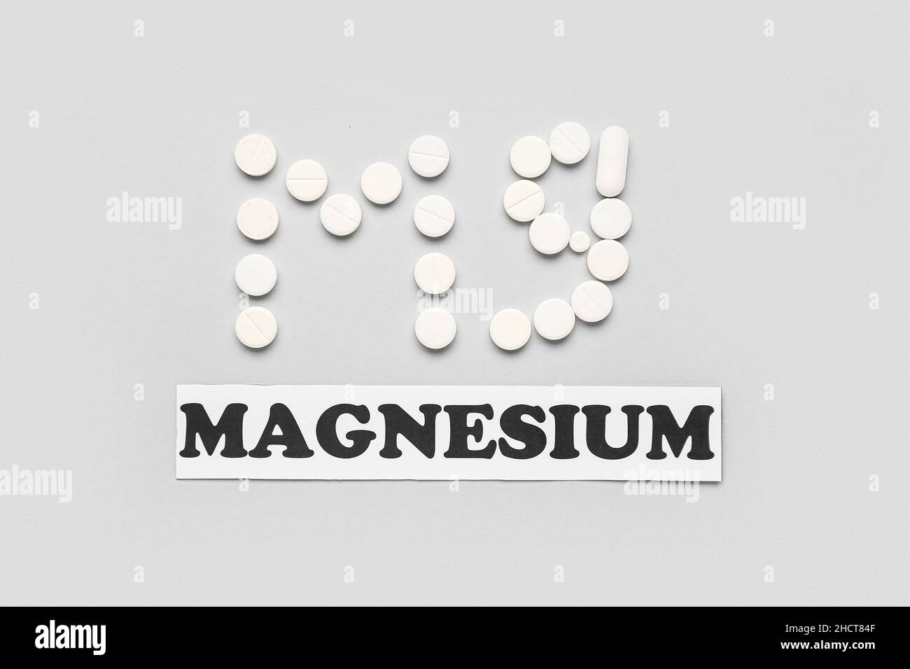 Mg element made of pills and word MAGNESIUM on light background Stock ...