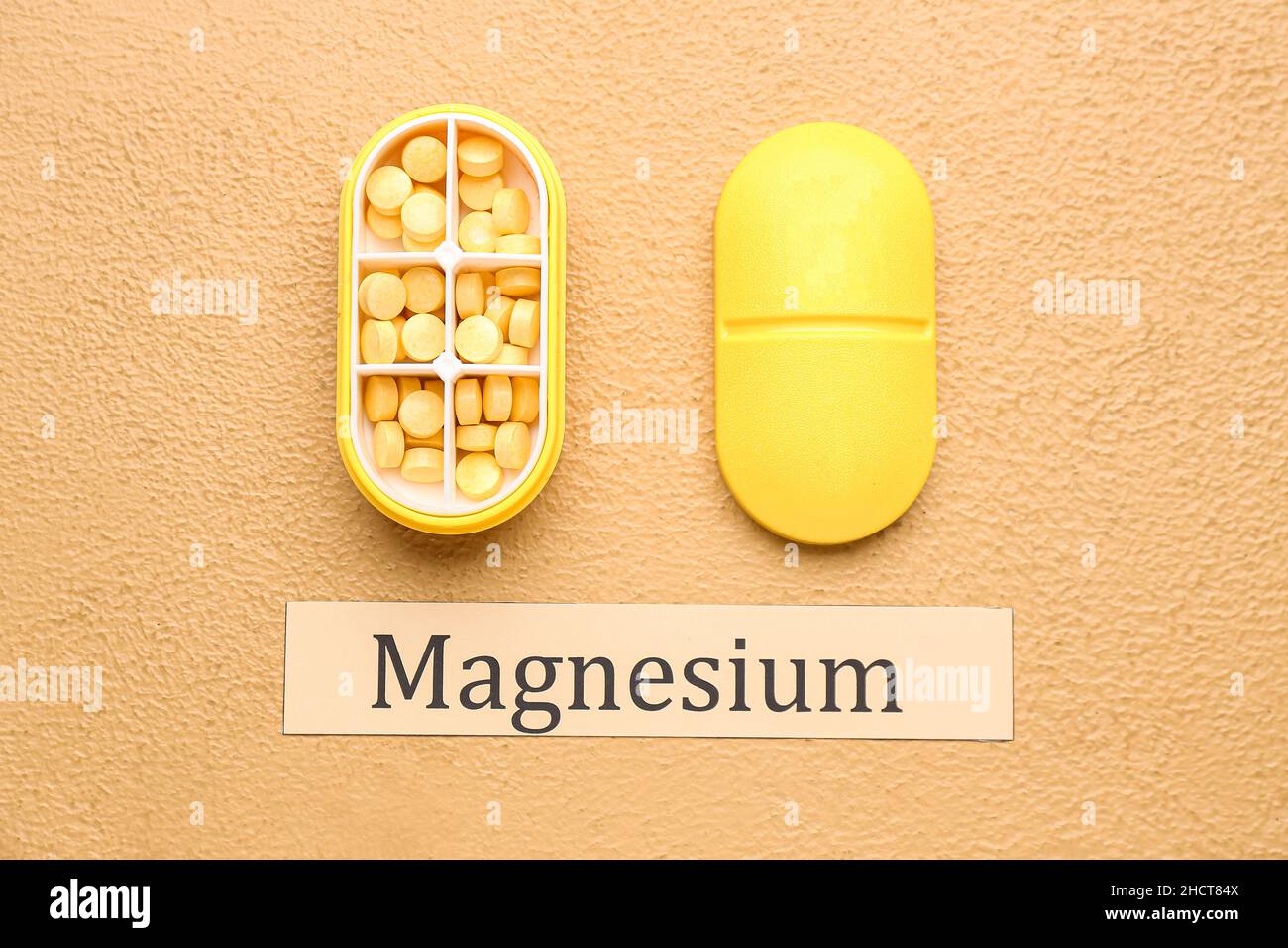 Word MAGNESIUM and container with pills on color background Stock Photo ...