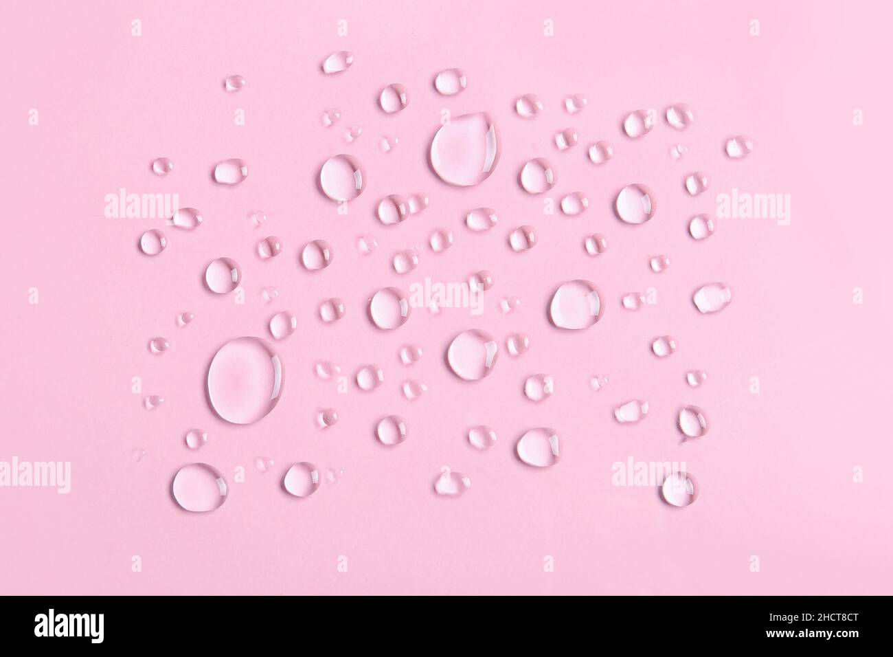 Water drops on pink background Stock Photo - Alamy