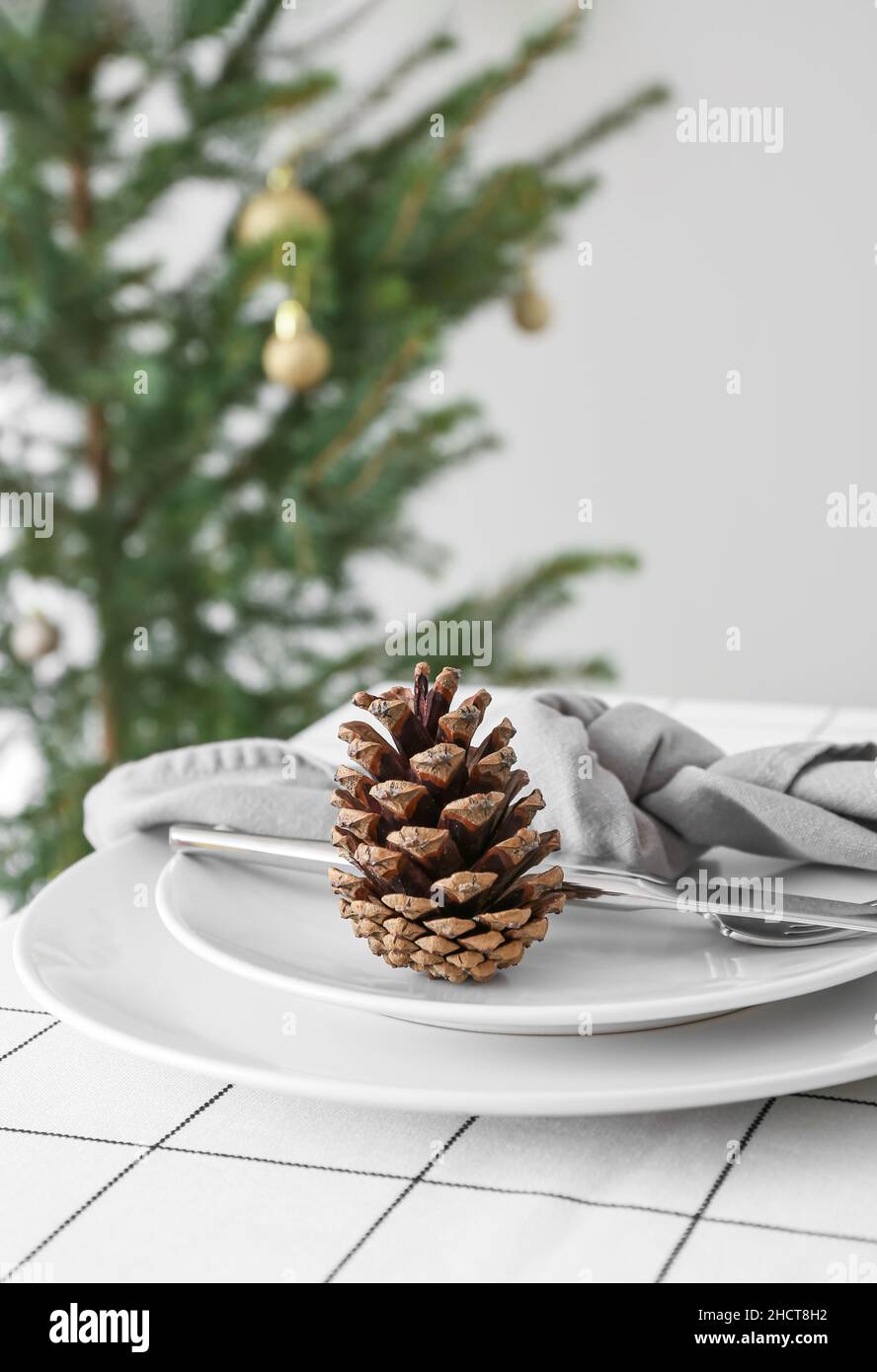 Beautiful table setting with pine cones indoors Stock Photo - Alamy