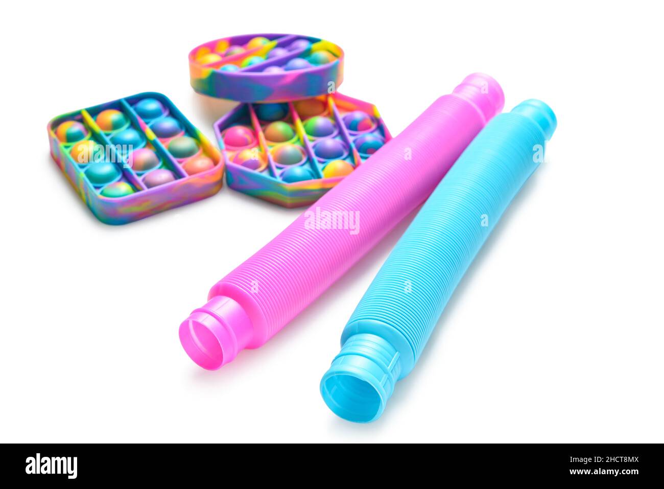 Colorful Pop Tubes and Pop it fidget toys on white background Stock ...