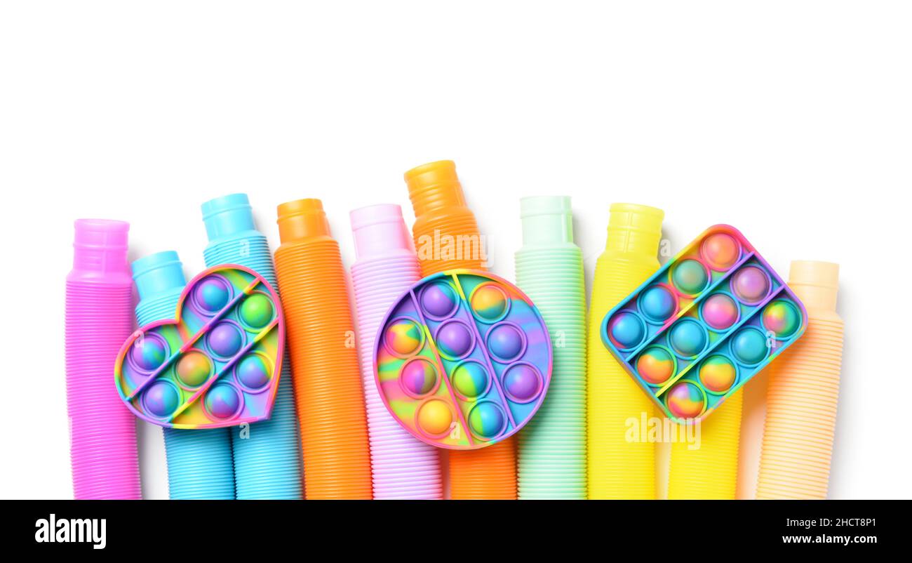Colorful Pop Tubes and Pop it fidget toys on white background Stock ...