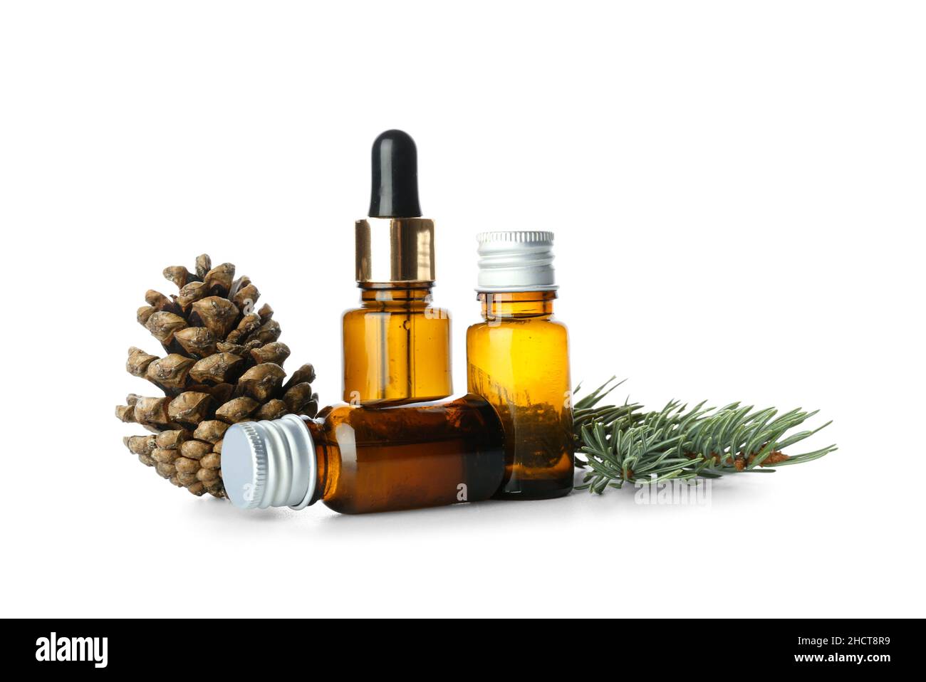 Bottles of essential oil, cone and fir branch isolated on white ...