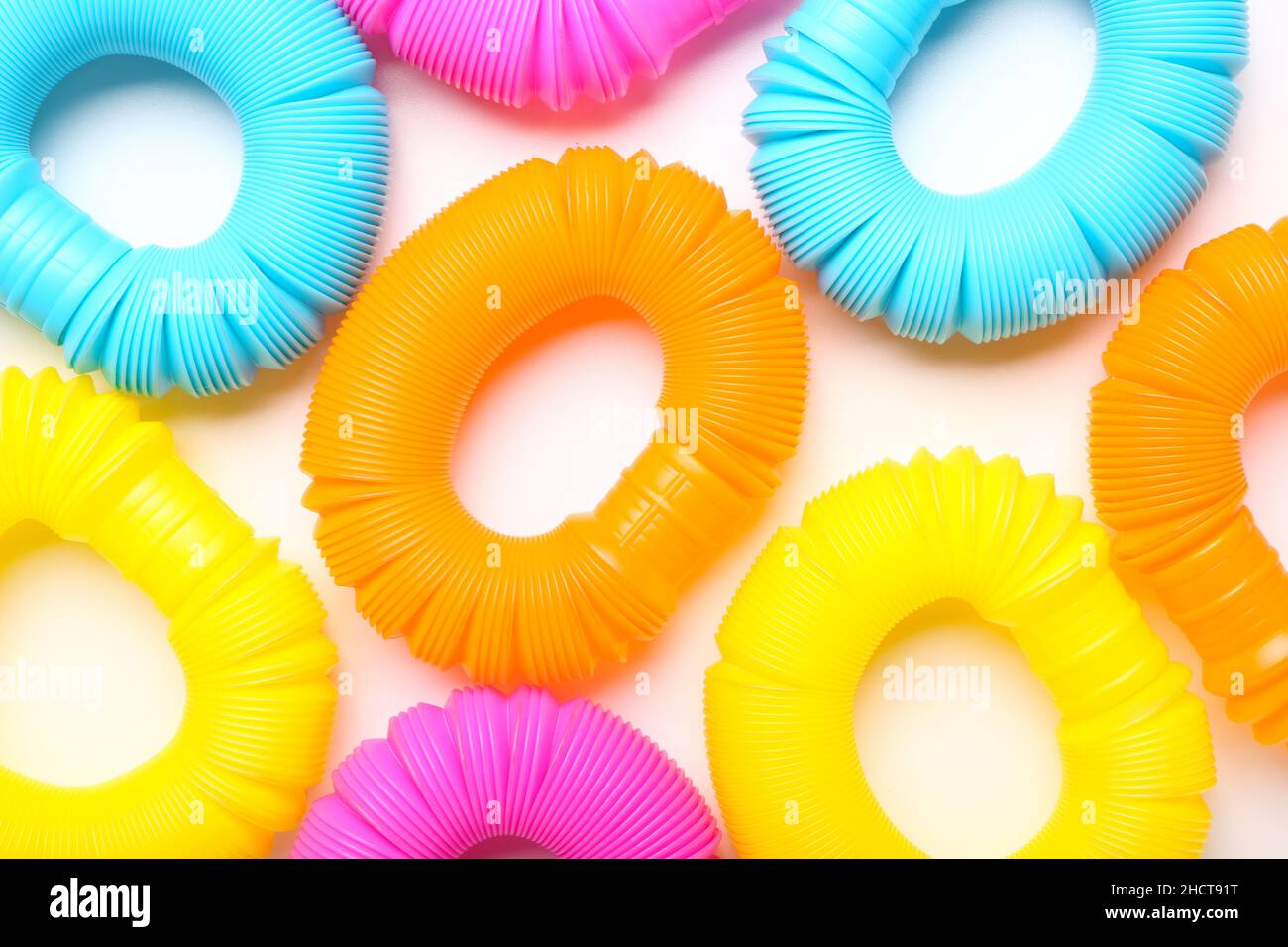 Different colorful Pop Tubes on white background Stock Photo - Alamy