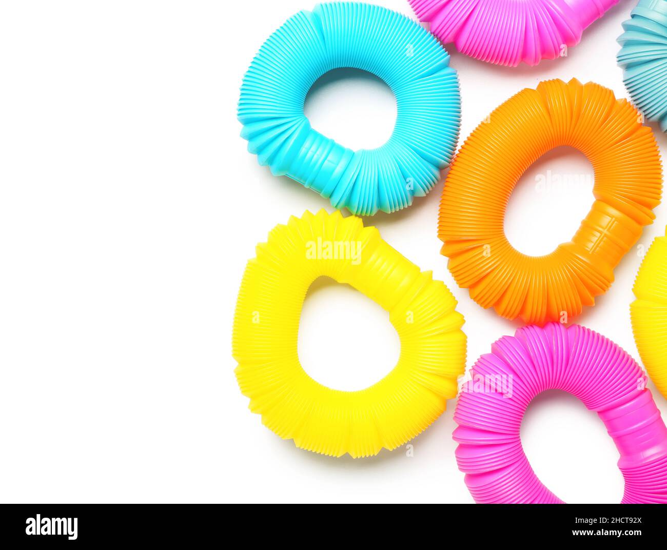 Different colorful Pop Tubes on white background Stock Photo - Alamy