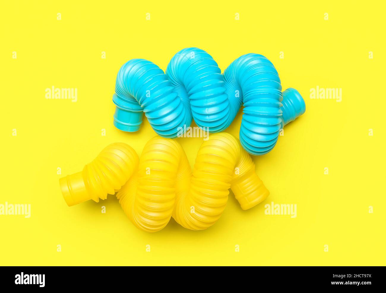Pop Tubes on yellow background Stock Photo - Alamy