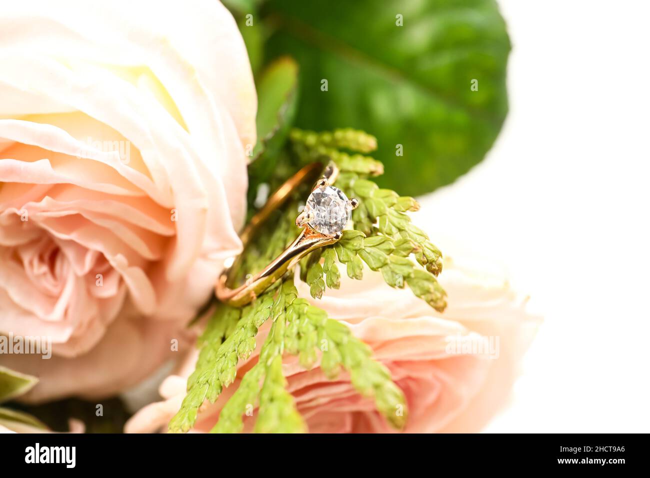 Golden engagement ring with roses on white background, closeup Stock ...