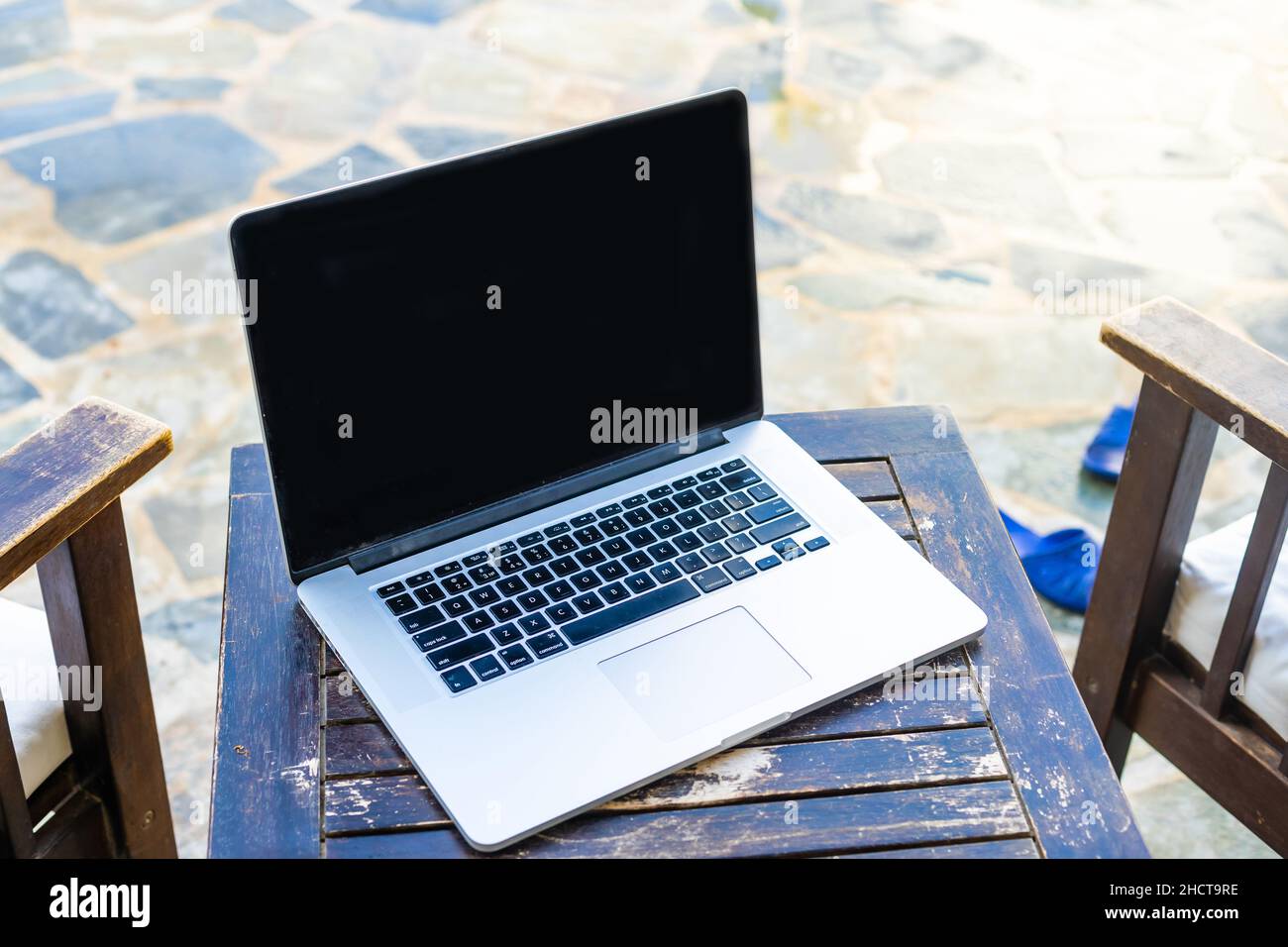 laptop computer on table pool background Stock Photo - Alamy