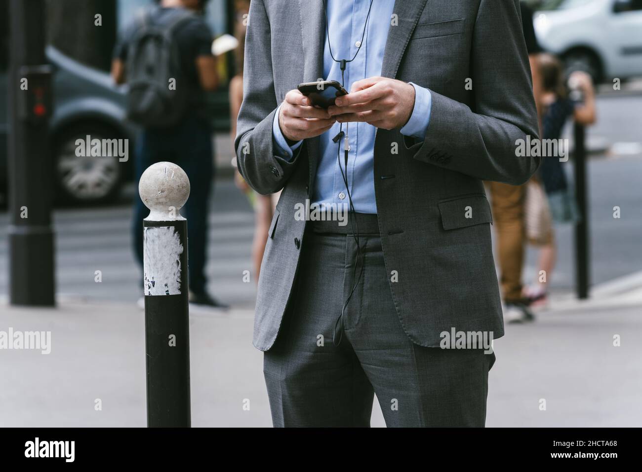 man outdoors using a smpartphone with a cable plugged into it Stock ...