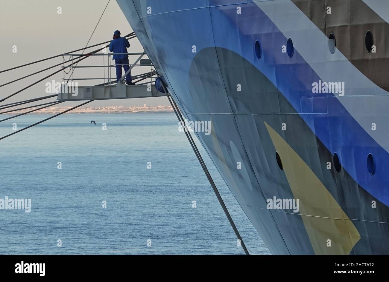 30 December 2021, Portugal, Lissabon: A member of the crew stands at ...