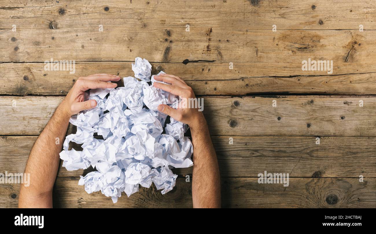 hands grab crumpled paper balls, copyspace for your individual text ...