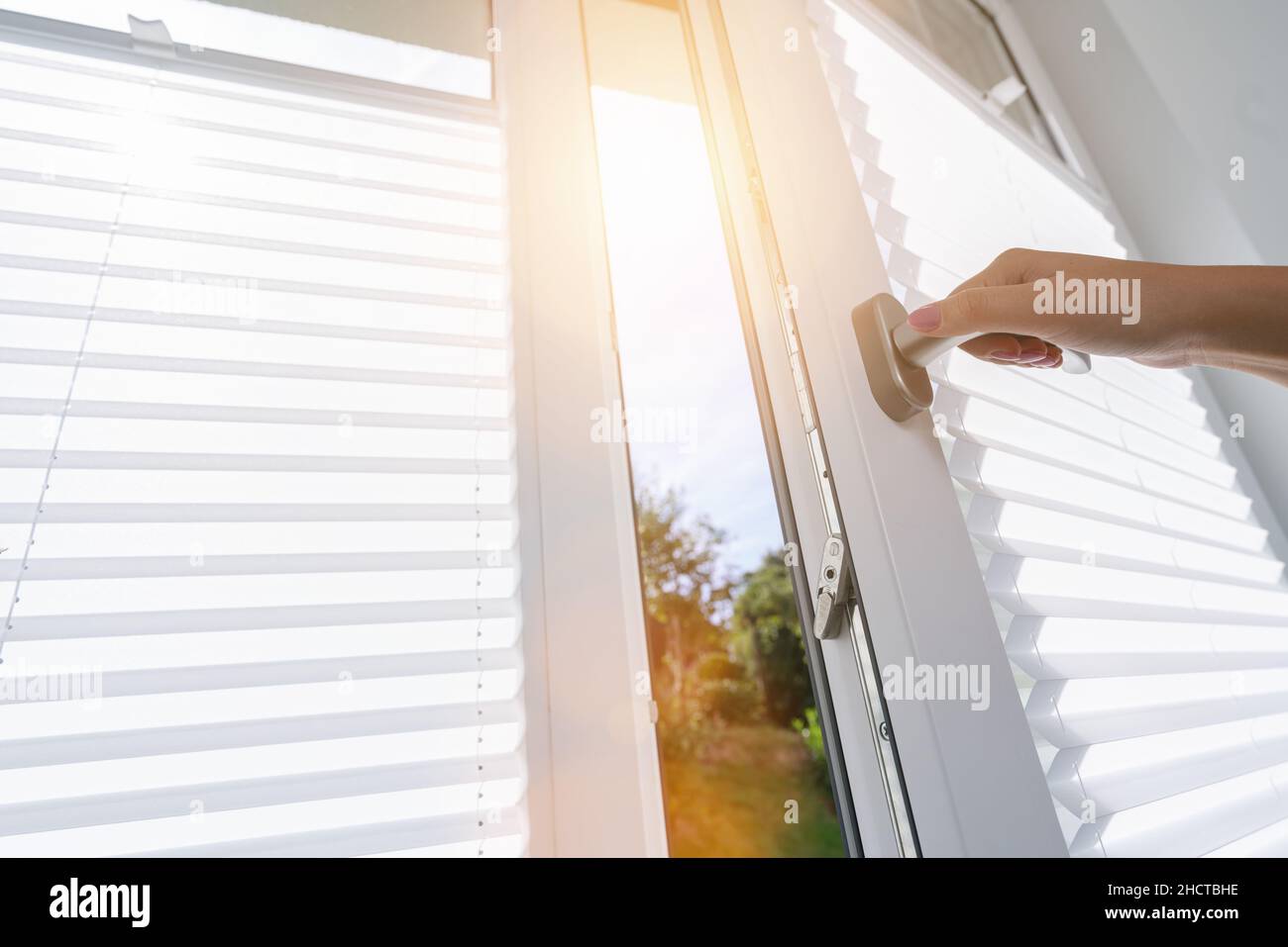 hand open a plastic pvc window with roller Stock Photo - Alamy