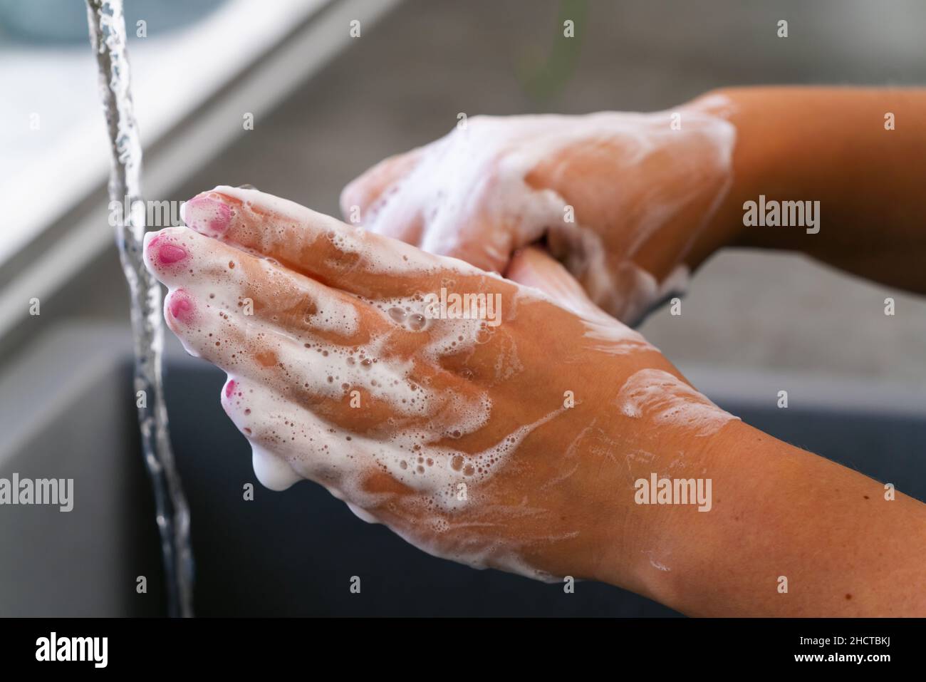 Washing of hands with soap under running water Stock Photo - Alamy
