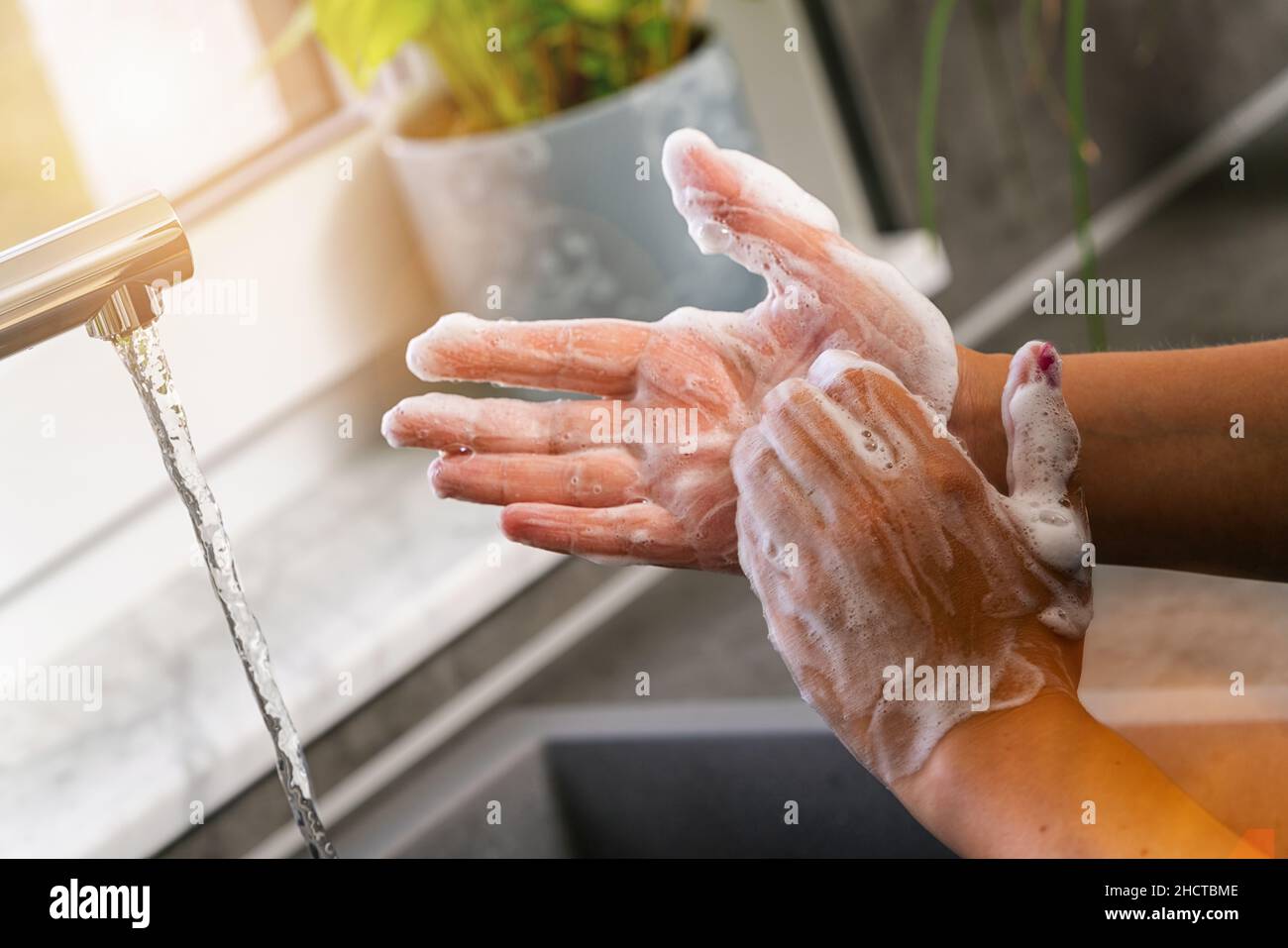 Hygiene. Cleaning Hands. Washing hands with soap in the kitchen Stock ...