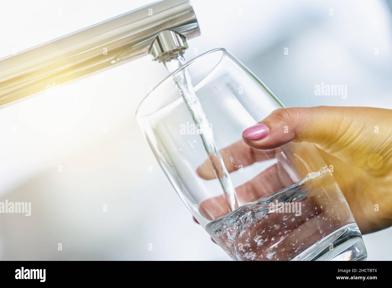 Woman hand's filling the glass of water Stock Photo - Alamy